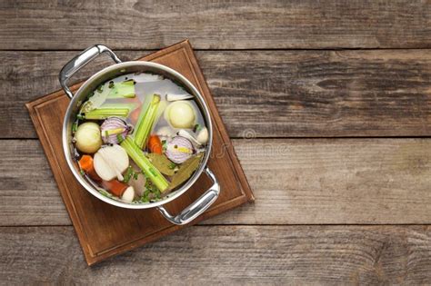 Different Ingredients For Cooking Tasty Bouillon In Pot On Wooden Table