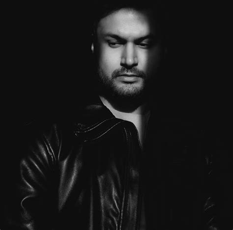 Portrait Of Man Wearing Leather Jacket In Shadow In Black And White