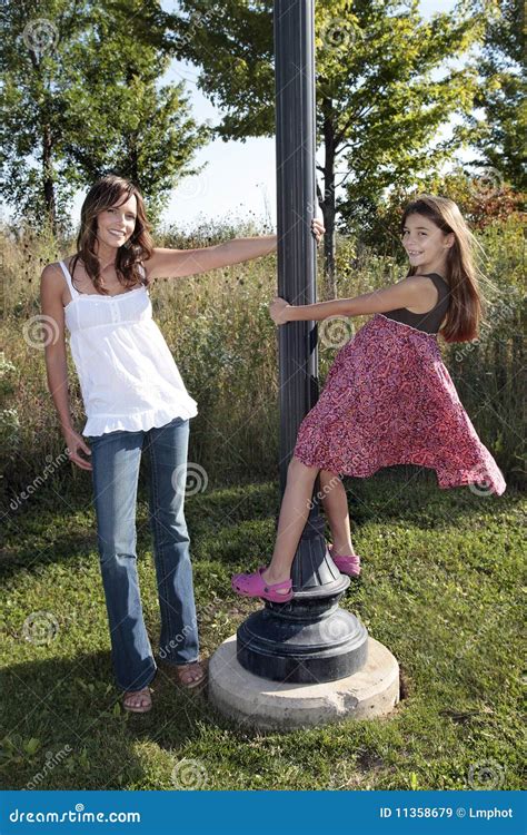 Mother And Daughter At Light Pole Stock Image Image Of Happiness