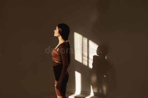 Young Caucasian Girl With Straightened Posture Stands Sideways In Empty