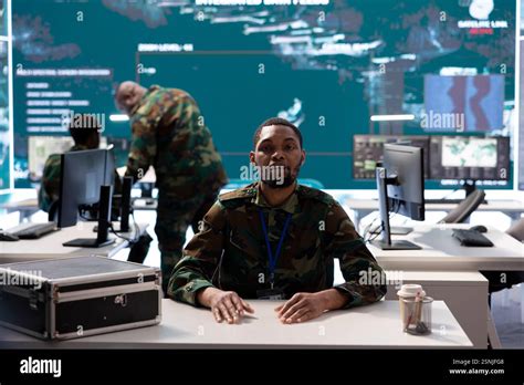 Army Soldier In A High Tech Monitoring Room Conducts A Videocall Leveraging Secure