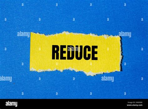 Reduce Word Written On Ripped Yellow Paper With Blue Background