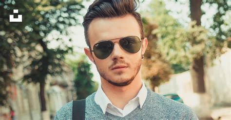 Man In Blue Sweater Wearing Black Sunglasses Photo Free Sweater Image