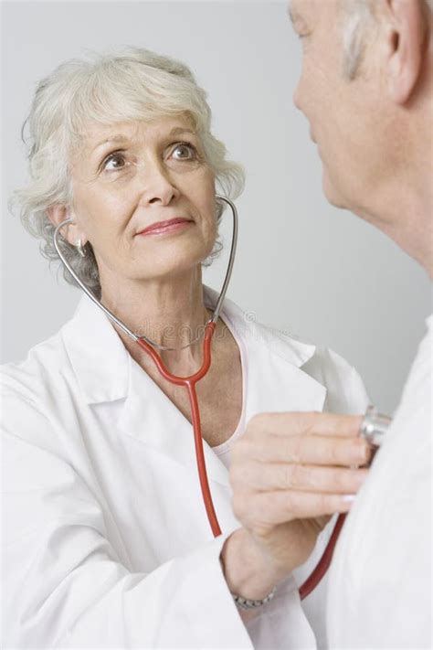 Doctor Checking Patients Heartbeat Using Stethoscope Stock Images