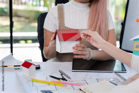 Female Architects Or Engineer Team Use Triangle Ruler To Measure The House Model Team Of