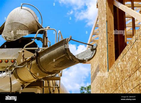 Mixer Truck Is Cement To Pouring Fresh Concrete Into A Foundation In