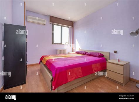 Bedroom With Wooden Beds With A Red Bedspread Many Mismatched