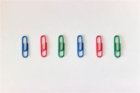 Premium Photo Close Up Of Colorful Paper Clips Over White Background