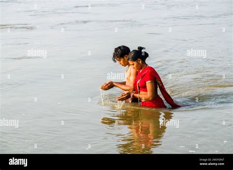Pilgrims Praying At Sangam The Confluence Of The Holy Rivers Ganges
