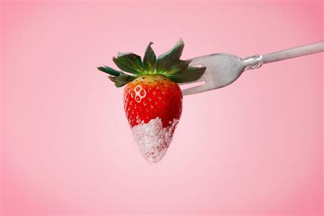 Premium Photo Delicious Red Strawberry Dipped In Sugar And Pierced With A Fork Nude Pink