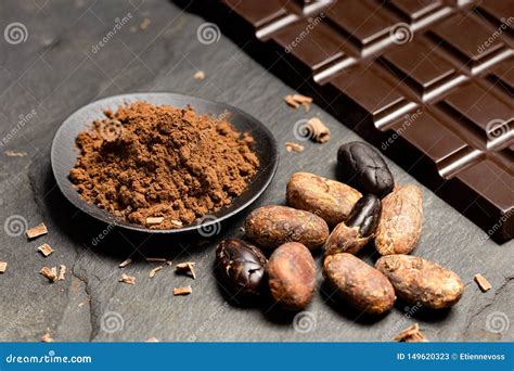 Cocoa Powder In A Black Ceramic Dish Next To Roasted Peeled And