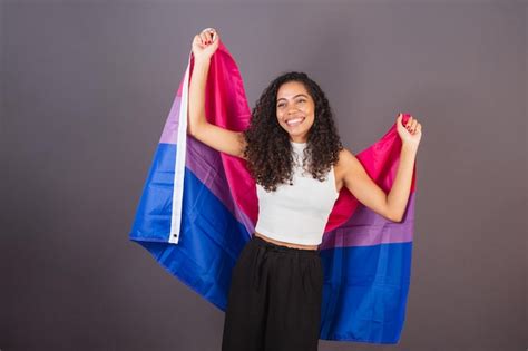 Premium Photo Young Brazilian Black Woman Raising Bisexual Flag