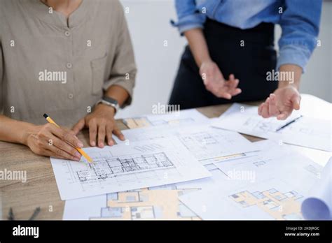 Concept Of Engineering Consulting Two Female Engineers Discussing About Blueprint Of