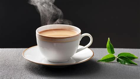 Hot Milk Tea Or Chai Served In White Cup Isolated On Dark Background