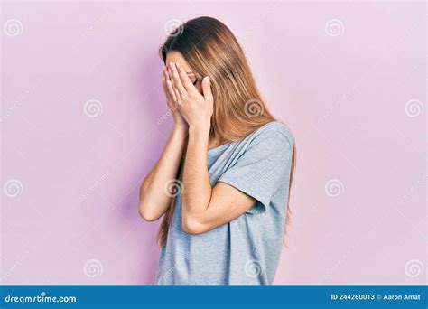 Young Blonde Girl Wearing Casual T Shirt With Sad Expression Covering