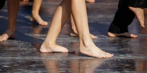 A Group Of People Are Barefoot On A Stage Stock Image Image Of Beach