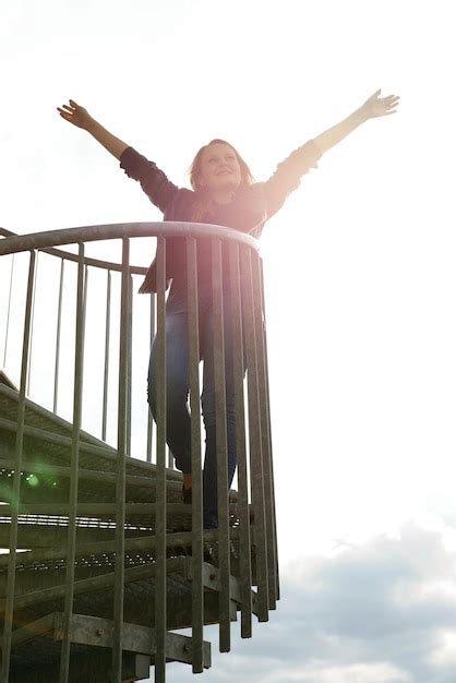 Premium Photo Woman With Hands Raised Against The Sky