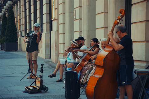 A Group Of People Playing Music On The Street Photo Free Street Image