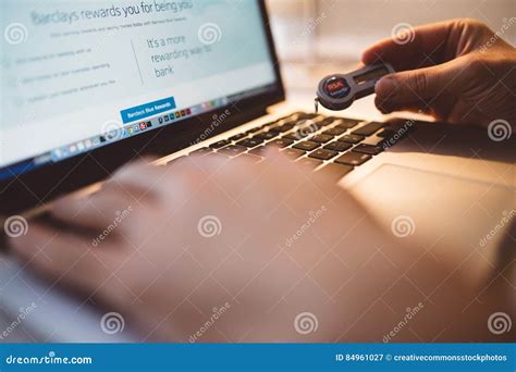 Person Holding Electronic Device While Using Its Macbook Laptop Picture