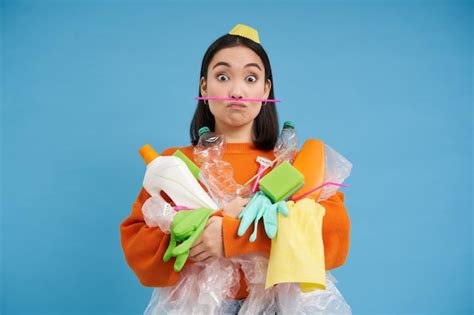 Premium Photo Portrait Of Cute Girl Blowing Bubbles Against Blue Background