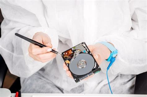Premium Photo Man Repairing Hard Drive In Service Center Repairing And Fixing Service In Lab