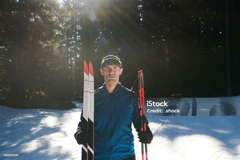 크로스 컨트리 스키를 손에 들고 고글을 쓰고 눈 덮인 숲에서 훈련하는 잘생긴 남자 운동선수를 초상화 건강 한 겨울 라이프 스타일 개념입니다 건강한 생활방식에 대한 스톡 사진