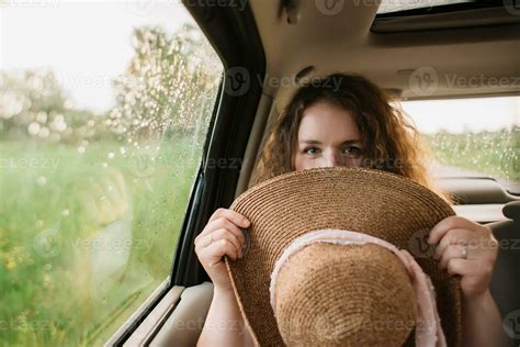 Cheerful Positive Curly Young Woman In Casual Wear Sitting In