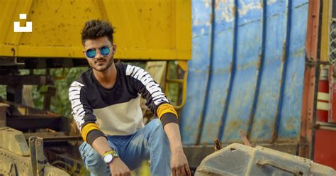 Man In Black And White Striped Long Sleeve Shirt And Blue Denim Jeans