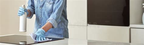 Smiling Mature Housewife In Rubber Gloves Looking Busy While Cleaning Kitchen Surface Using