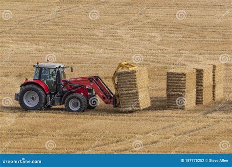 Agriculture A Tractor Collecting Bales Of Hay Editorial Photography
