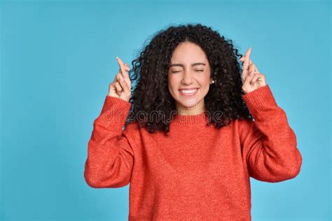 Young Latin Woman Crossing Fingers Isolated On Blue Background Stock
