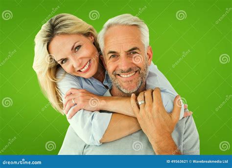 Composite Image Of Happy Couple Standing And Hugging Stock Image