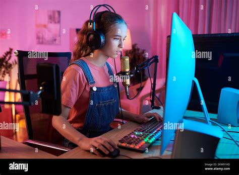 Teenage Girl Streaming Video Of Herself Playing Videogame In Neon Room