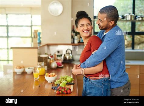 Sorry Am I Distracting You A Handsome Young Man Embracing His Wife