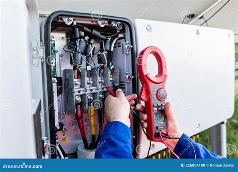 The Inspector Checks The Actual Output Voltage Level Of Inverter Stock Photo Image Of