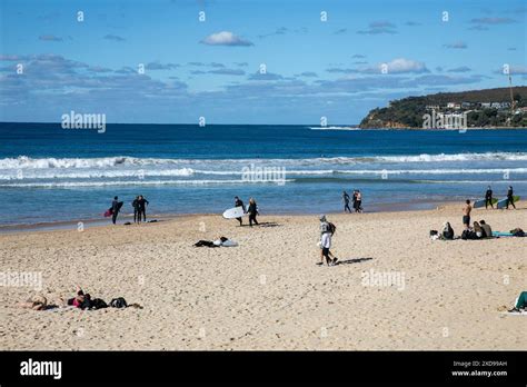 Manly Beach In Sydney Busy With Surfers On The Beach Carrying