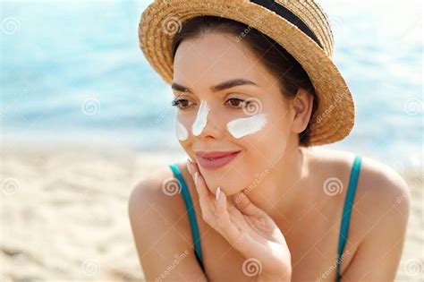 Beautiful Woman Applying Cream Sunscreen On A Tanned Face Sunscreen