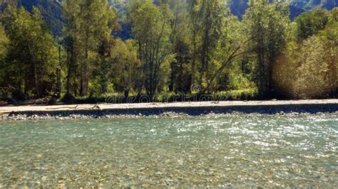 Tiny Clear Cold River With Boulder Rocks In Arkhyz Mountain Ridge