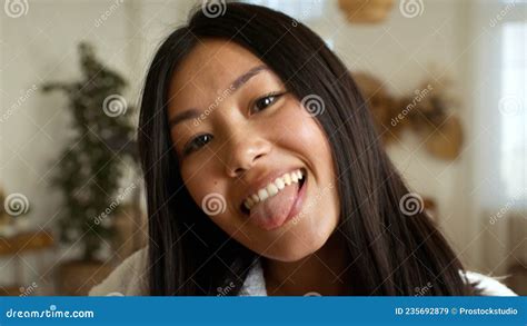 Young Playful Asian Lady Fooling Around Sticking Out Her Tongue And