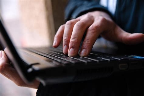 Premium Photo Mens Hand Typing On A Laptop Keyboard Selective Focus