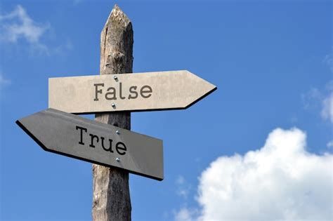 Premium Photo True And False Wooden Signpost With Two Arrows Sky With Clouds