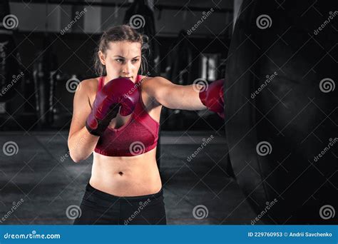 Attractive Young Woman Boxing At The Gym Female Boxer Preparing For