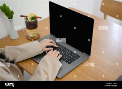 Closeup Female Officer Working On Laptop Computer Typing Her Work Assignment Sitting In Cafe
