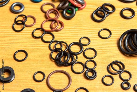 Black Hydraulic And Pneumatic O Rings In Different Sizes On A Wooden