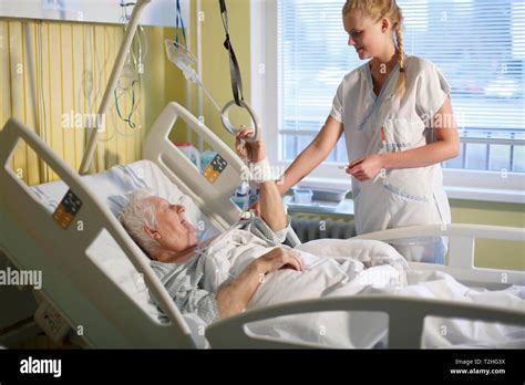 Nurse Takes Care Of A Patient In A Hospital Bed Czech Republic Stock