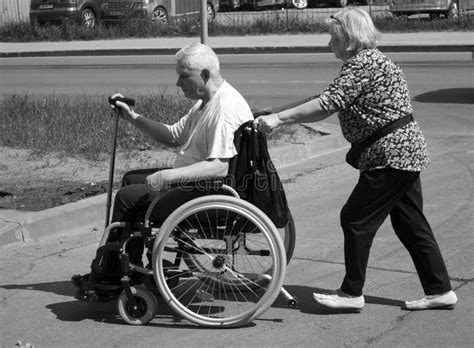 Old Woman Carries Disabled Carriage With Old Man Editorial Photo