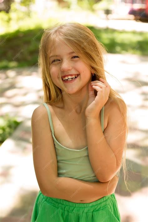 Premium Photo Beautiful Happy Longhaired Blonde Girl In A Green Suit