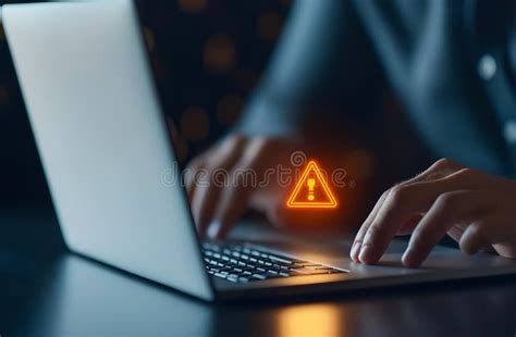 Person Using Laptop With Warning Symbol Displayed On Screen Indicating