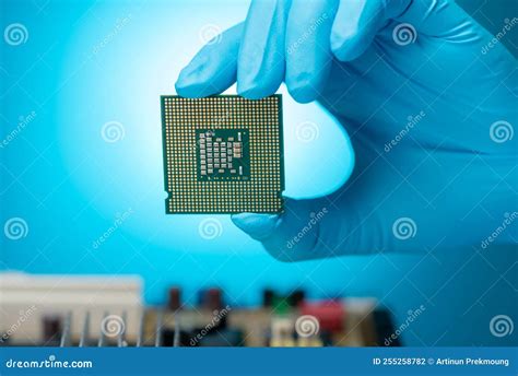 Electronic Engineer Hand Holding Computer Chip On Blue Background Chipset Of Electronic Circuit