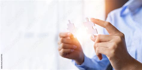 Cropped Shot Of Businesswoman Hand Connecting Jigsaw Puzzle With Sunlight Effect Business